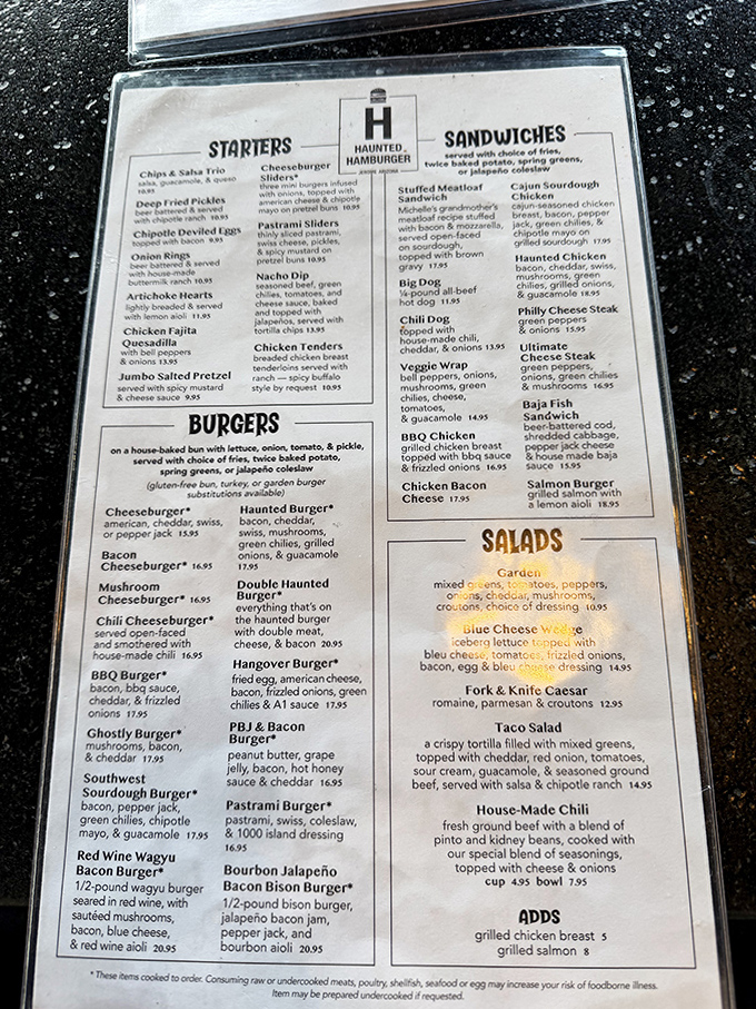 The menu reads like a love letter to burger enthusiasts, with options ranging from the signature Haunted Burger to creative sandwiches and hearty appetizers.