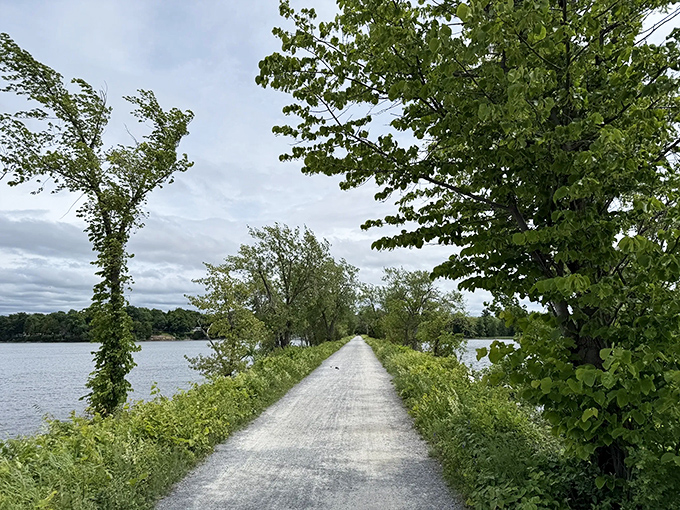 Moody skies create dramatic backdrops along this narrow ribbon of path, where every step brings new perspectives of Lake Champlain.