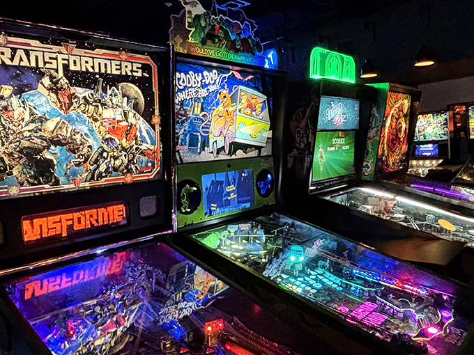Row upon row of pinball machines stand at attention, their playfields a kaleidoscope of colors waiting for the perfect flipper shot.