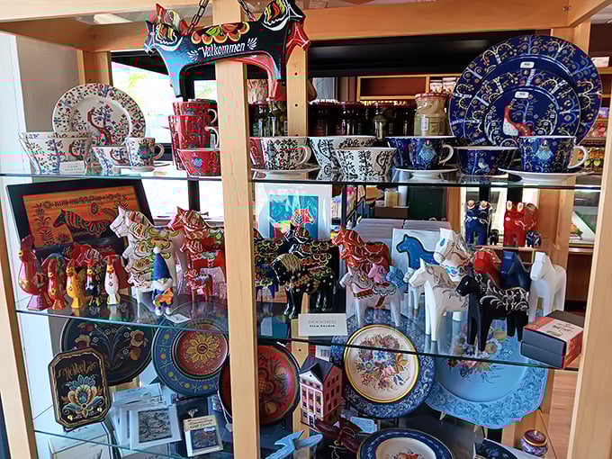 Colorful Dala horses and hand-painted ceramics create a miniature Sweden on shelves, each piece more charming than the last.
