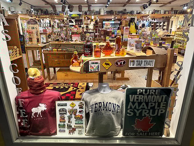 The window display showcases Vermont pride with cozy apparel, maple products, and that unmistakable Green Mountain State spirit.