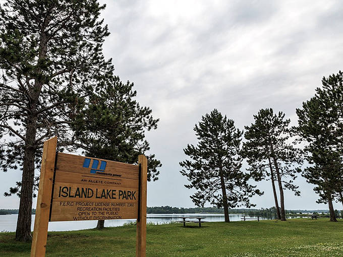 Island Lake Park welcomes visitors with its wooden entrance sign, promising lakeside relaxation and outdoor adventures just minutes from Duluth.
