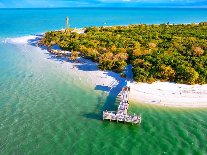 The lighthouse stands sentinel on Captiva's shore, where the island's pristine beaches meet waters so clear you can count fish from the pier.