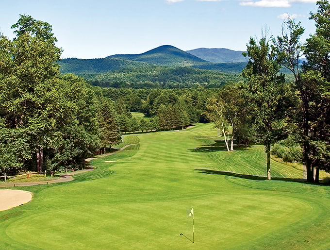 Golf paradise: Emerald fairways roll toward mountain vistas, tempting even non-golfers to grab a club and take a swing.