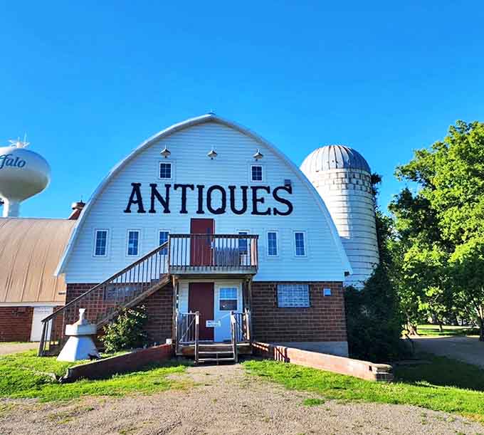 Buffalo Nickel Antiques charms visitors with its picturesque white barn structure and silo, a perfect setting for vintage hunting.