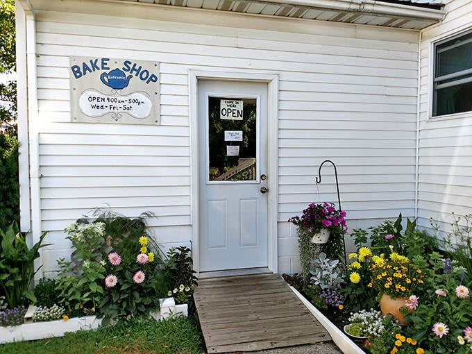 Country Cookstove's flower-framed entrance invites you into a world of traditional baking. The wooden bench practically begs you to sit and savor your treats!