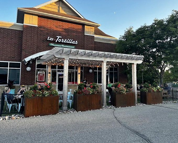 Las Tortillas' inviting patio features a beautiful pergola adorned with string lights, creating the perfect outdoor setting for enjoying authentic tacos in Rosemount.