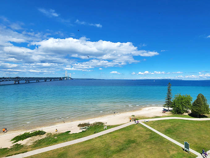 The mighty Mackinac Bridge stretches across the straits, connecting Michigan's two peninsulas. From this beach viewpoint, you can almost hear the waves whispering tales of Great Lakes history.