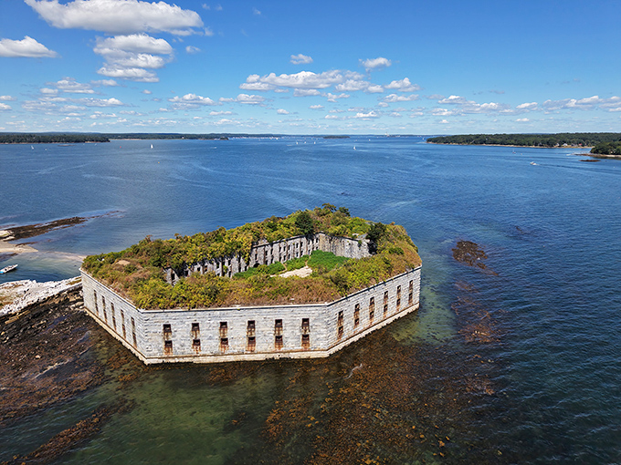 Fort Gorges sits abandoned in Portland Harbor, its weathered granite walls holding secrets and shadows perfect for ghost stories.