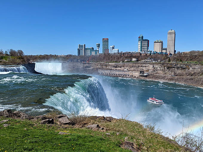 Niagara's American Falls thunder down with raw power, while tiny tour boats brave the swirling mist for an up-close encounter.