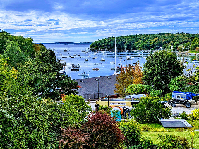 Rockport Harbor dazzles with its perfect blue waters dotted with sailboats, surrounded by lush green hills.