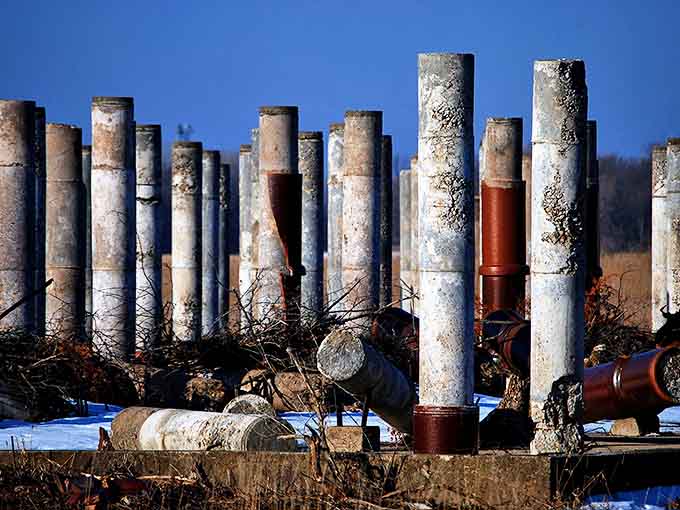UMore Park's abandoned buildings stand like forgotten movie sets, their wooden bones weathering quietly under Minnesota skies.