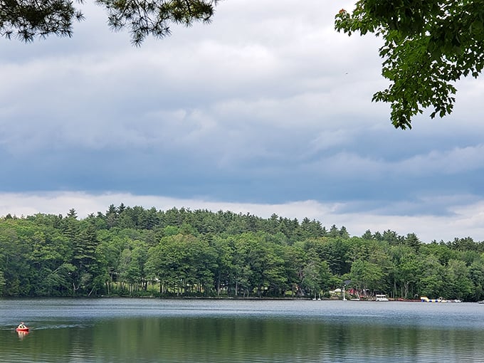 Washington Pond showcases Maine's famous fall colors, with trees ablaze in reds and oranges reflecting perfectly in the crystal-clear waters.