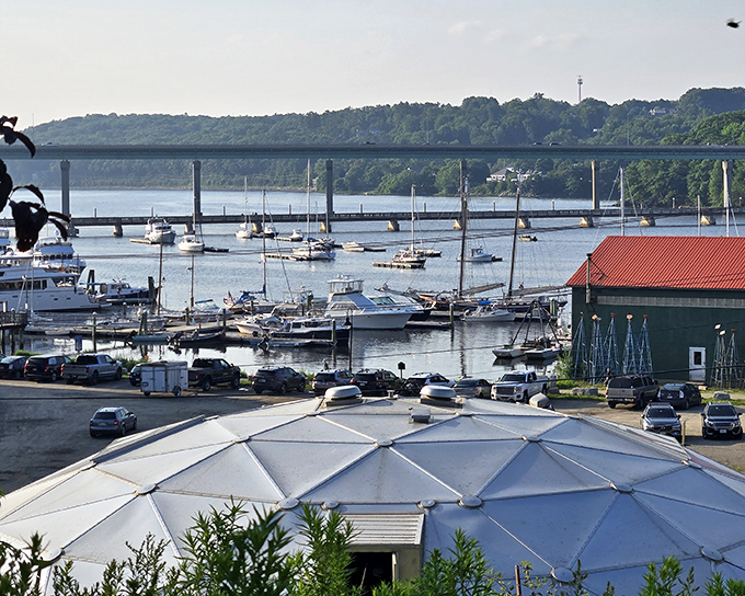 Belfast's pristine lakeside view creates a picture-perfect setting with crystal-clear waters reflecting the surrounding trees in stunning symmetry.