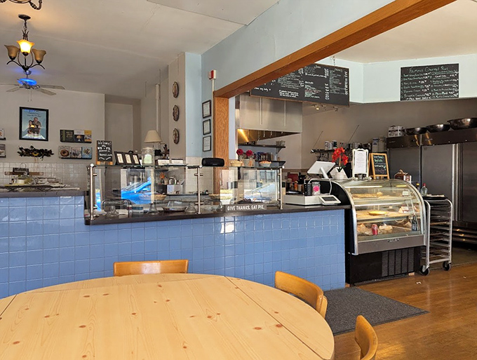 The cozy interior of Dave the Pie Guy features a glass case displaying the day's freshly baked treasures, just waiting for you to make your selection.