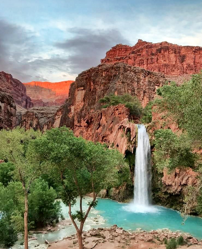 The stunning blue-green waters of Havasu Falls create a paradise in the desert that rewards hikers who make the challenging journey.