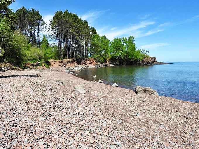 The shoreline at Iona's Beach curves gently between rocky outcroppings, offering a secluded spot to enjoy Lake Superior.