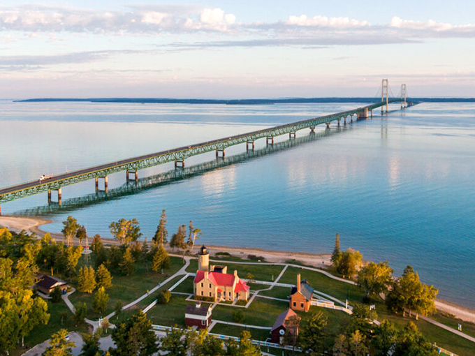 The mighty Mackinac Bridge stretches across the horizon, connecting Michigan's two peninsulas like a green ribbon across blue waters.