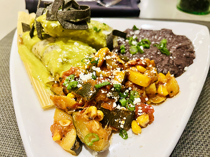 The enchanting entrance to Gertrude's glows with warm light, inviting diners into this botanical garden oasis after sunset.