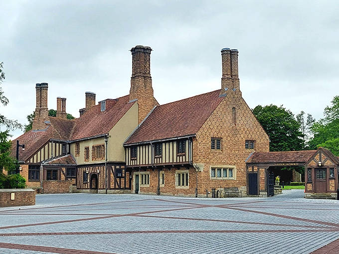 The mansion's brick facade and towering chimneys create a silhouette worthy of a period drama set against Michigan's seasonal palette.