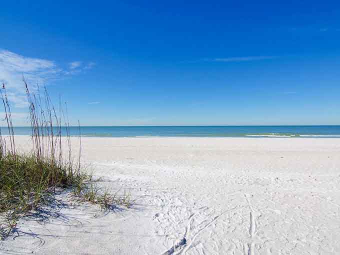 Pure white sand meets impossibly blue water, creating the kind of view that makes your camera roll very happy.