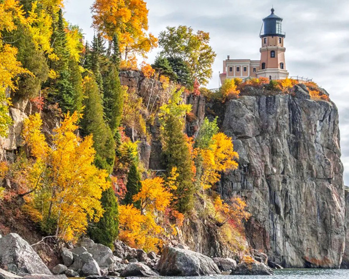 Autumn transforms Split Rock Lighthouse State Park into a painter's palette, with golden trees framing the iconic lighthouse against the deep blue of Lake Superior.