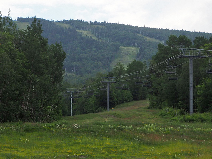 The quiet chairlifts of Sugarloaf's off-season offer a peaceful ascent through mountain terrain, revealing views that skiers miss when the slopes are covered in white.