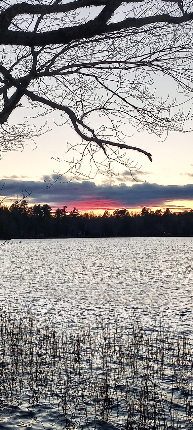 Twilight settles over Washington Pond's glassy surface, creating that magical moment when day meets night over some of Maine's clearest swimming waters. 