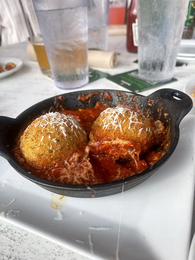Arancini: These golden orbs of risotto goodness swim in marinara like delicious meteors that crashed into a tomato sea.