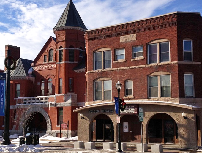 The distinctive brick architecture with its charming turret speaks to an era when movie theaters were designed as landmarks, not just functional boxes.