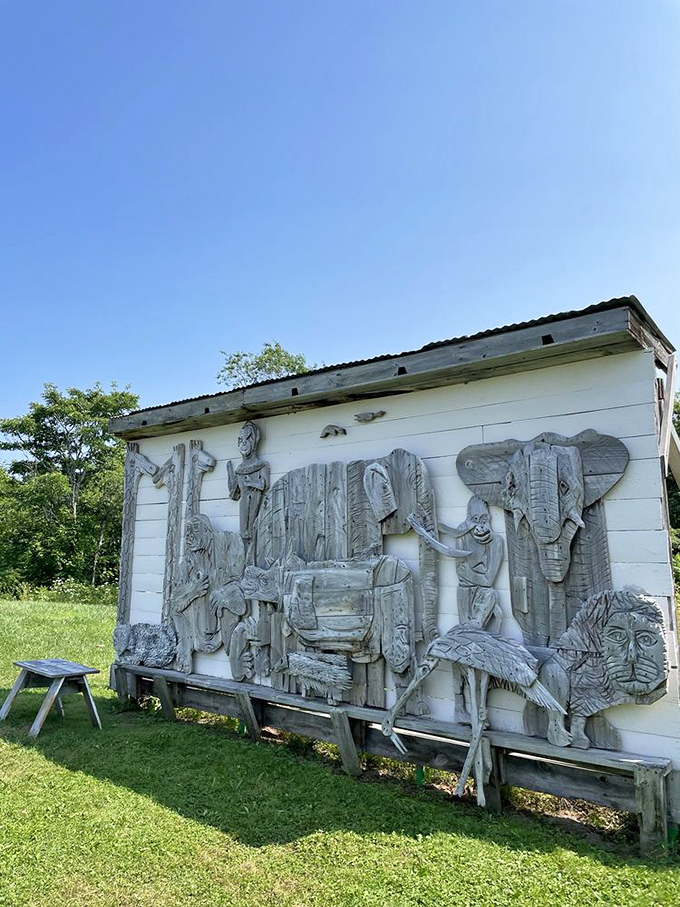 Weathered wooden animals adorn the side of a building, their simple forms capturing the essence of Maine's wildlife with rustic charm.