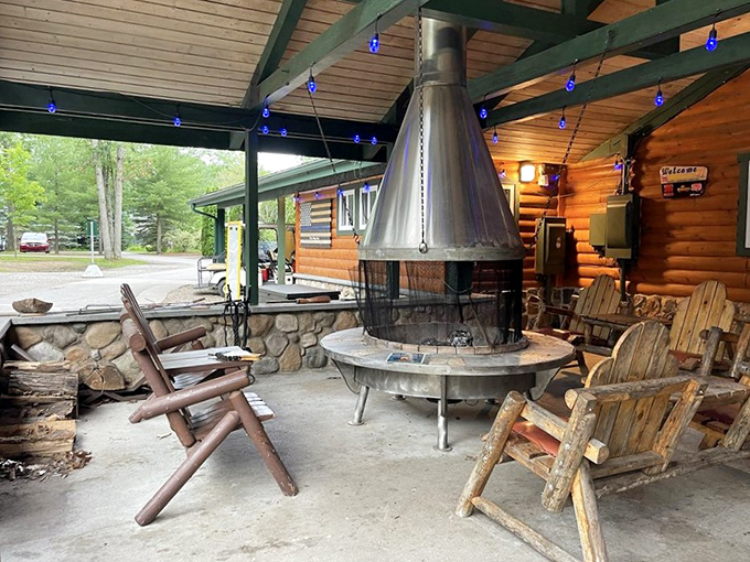The covered patio area with its central fireplace becomes the heart of evening gatherings, where strangers become friends over shared s'more techniques.