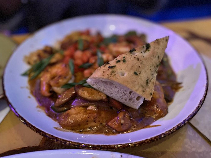 The Creole Chicken & Shrimp Ravioli brings Cajun flair to prehistoric dining &ndash; pasta pillows swimming in a sauce that would make even velociraptors purr.