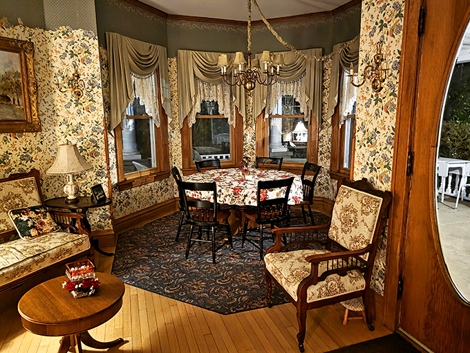 Breakfast conversations flow easily in this dining room, where floral patterns compete for attention and antique furniture tells silent stories.