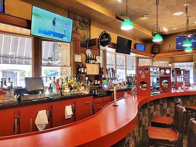 The Leprechaun Lounge's curved red bar has hosted countless conversations and celebrations, its green pendant lights casting a nostalgic glow over patrons.