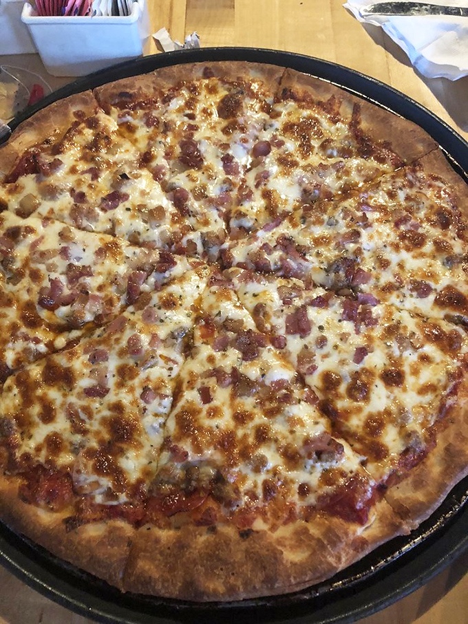 The Dragon Feast pizza arrives like a conquering hero, pepperoni and ham glistening atop melted cheese that stretches with each heavenly bite.