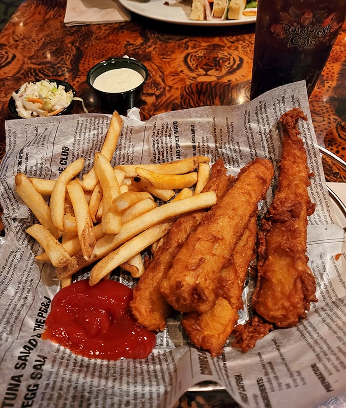 Classic fish and chips arrive newspaper-style &ndash; crispy, golden batter protecting flaky white fish that would make any British pub proud.