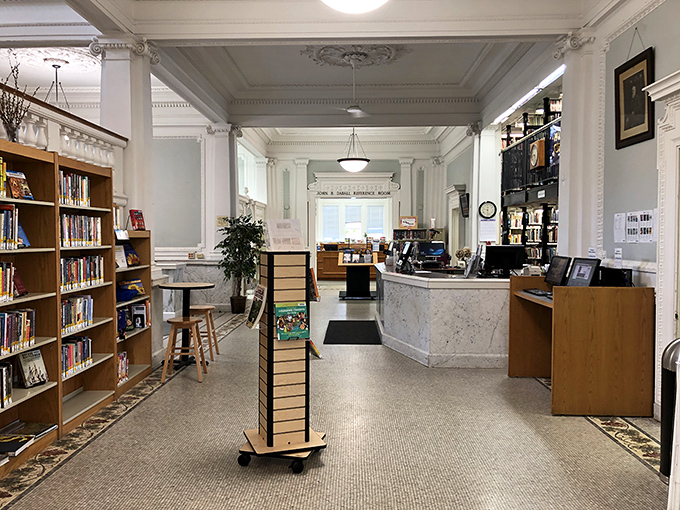 The circulation desk blends historical charm with modern functionality, where friendly staff connect visitors with literary treasures old and new.