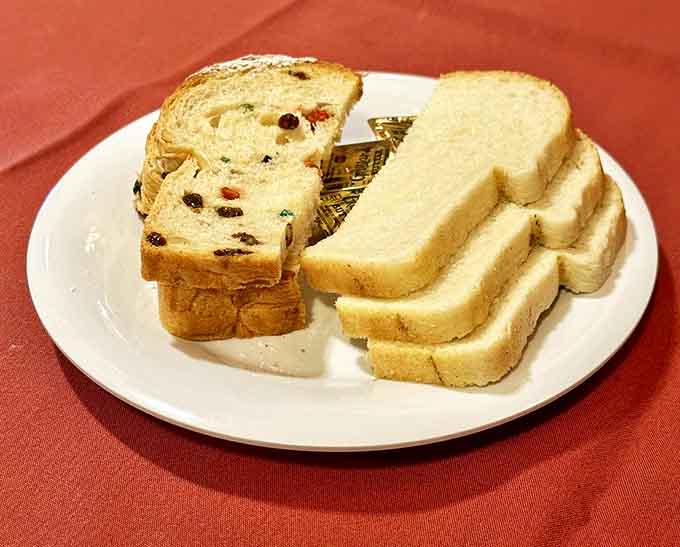 Fresh-baked bread varieties showcase the bakery's artistry - from fruit-studded loaves to classic white bread, each slice tells a story of tradition.
