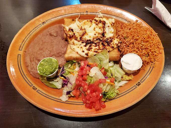 This plate doesn't just hold food &ndash; it cradles a perfect balance of grilled chicken, refried beans, and Mexican rice.