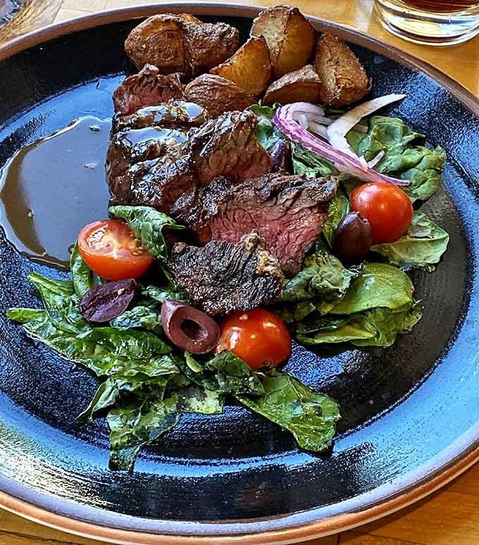 This grilled hanger steak isn't just dinner &ndash; it's a masterclass in simplicity done right, with a perfect crust and seasonal accompaniments that let quality ingredients shine.
