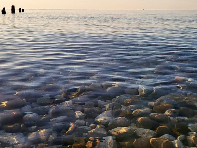 The Great Lake at its most serene, with stones beneath the surface creating a stained-glass effect in the crystal-clear shallows.