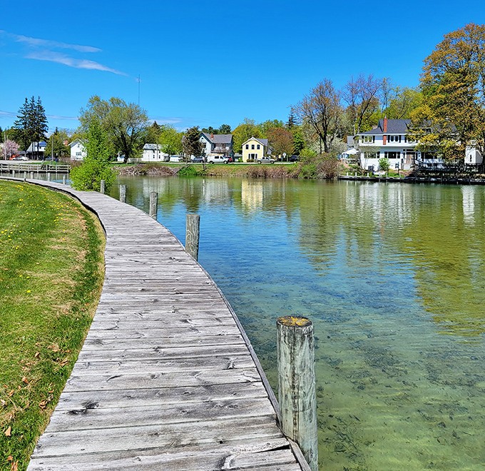 Strolling Leland's wooden boardwalk feels like walking through a postcard – crystal waters below, charming shops above, and possibility around every corner.