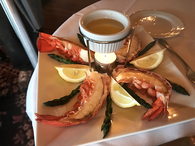 Ocean meets elegance as perfectly prepared lobster tails are artfully arranged with fresh asparagus and lemon wedges&mdash;a feast fit for royalty.