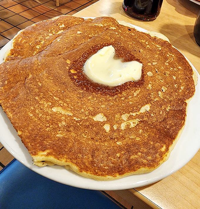 This isn't just a pancake, it's an edible frisbee of joy that requires its own zip code and possibly building permit.