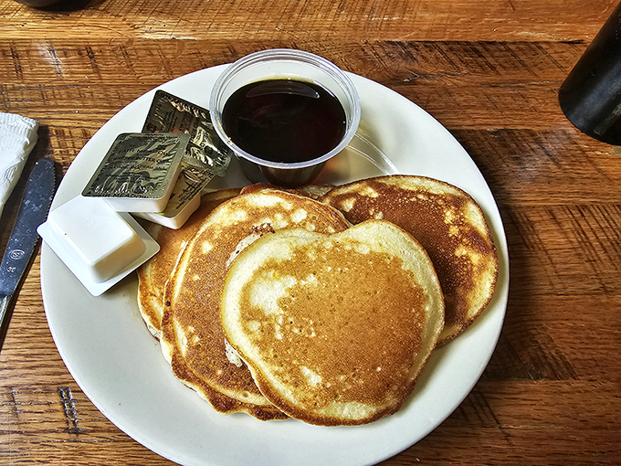 Golden pancakes that absorb syrup like they were engineered for it – breakfast doesn't get more comforting than this.