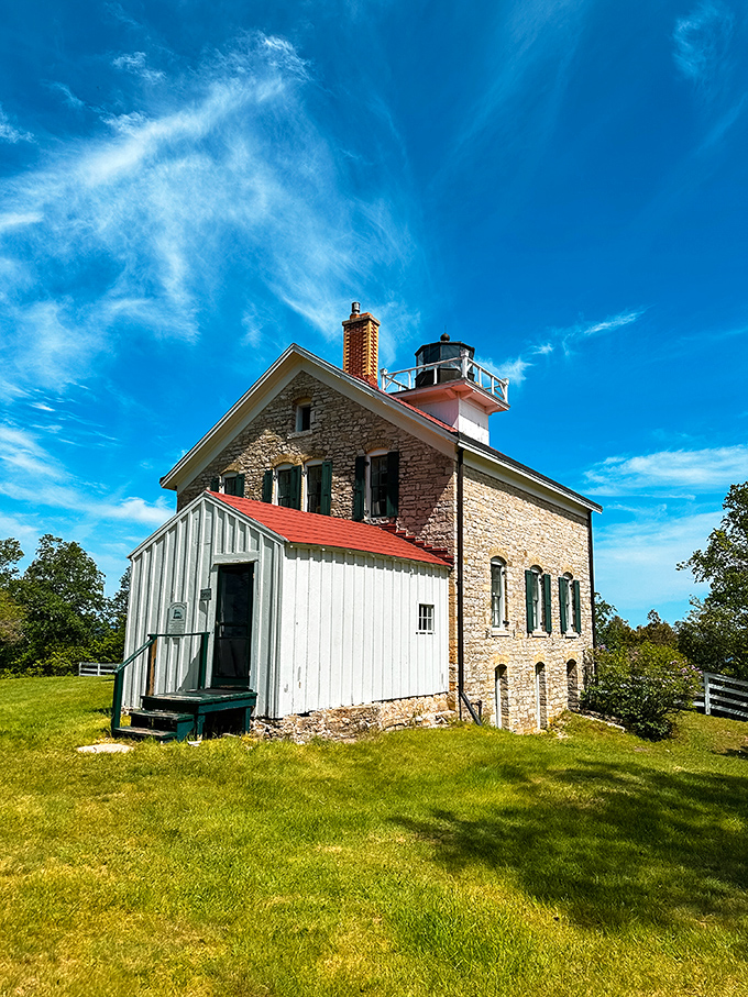 This charming lighthouse has been guiding sailors since 1858, standing sentinel over Death's Door passage like a faithful guardian of maritime history.