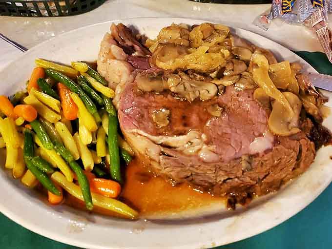 Prime rib that looks like it belongs in a magazine spread, served with vegetables colorful enough to make you forget you're eating healthy.