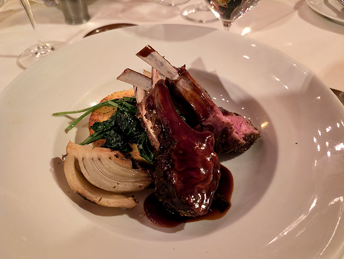 Rack of lamb presented with artistic precision &ndash; meat cooked to perfection alongside vibrant vegetables that taste as good as they look.