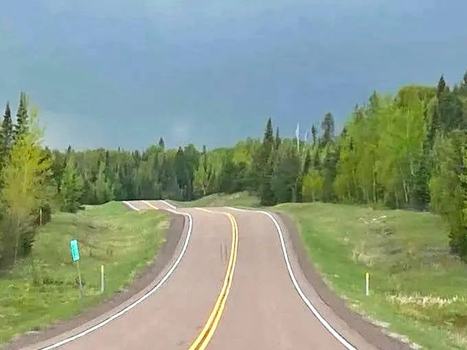 The open road calls to road-trippers as Highway 1 disappears into Minnesota's vast wilderness, where cell service fades but stories begin.
